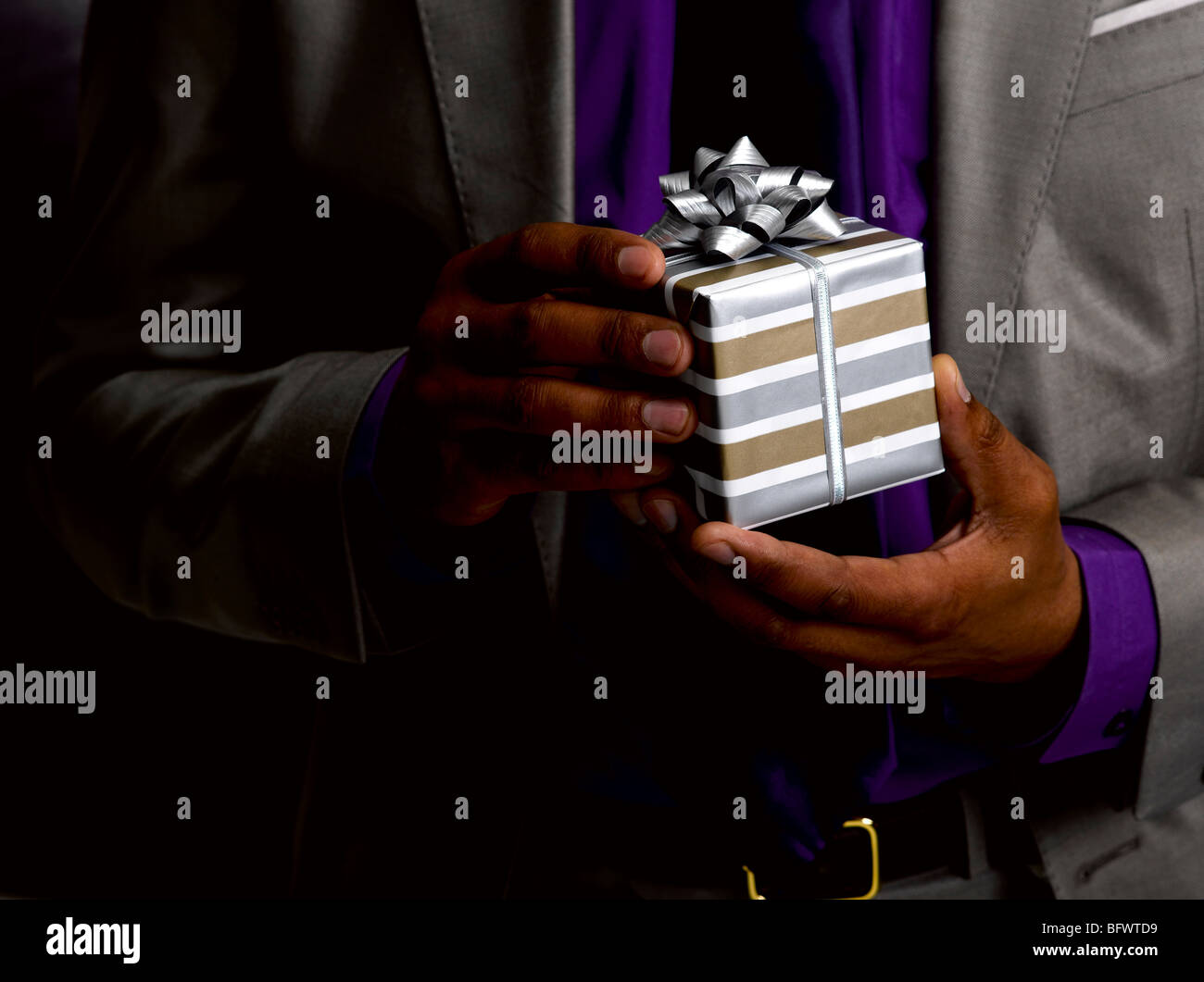 Business man holding gift Stock Photo - Alamy