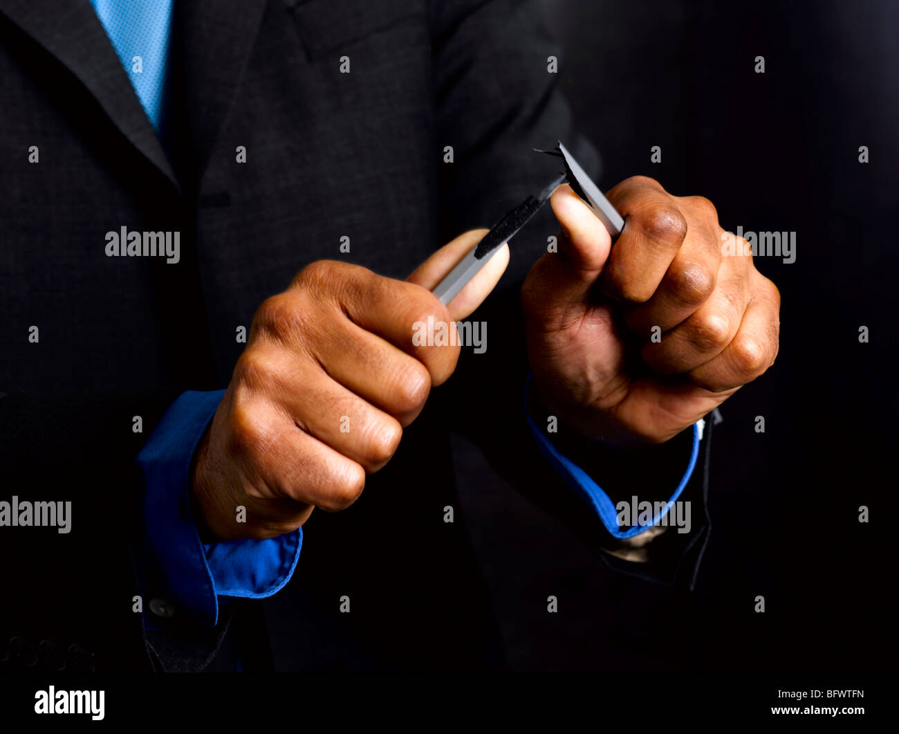 Business man breaking pencil in half Stock Photo - Alamy