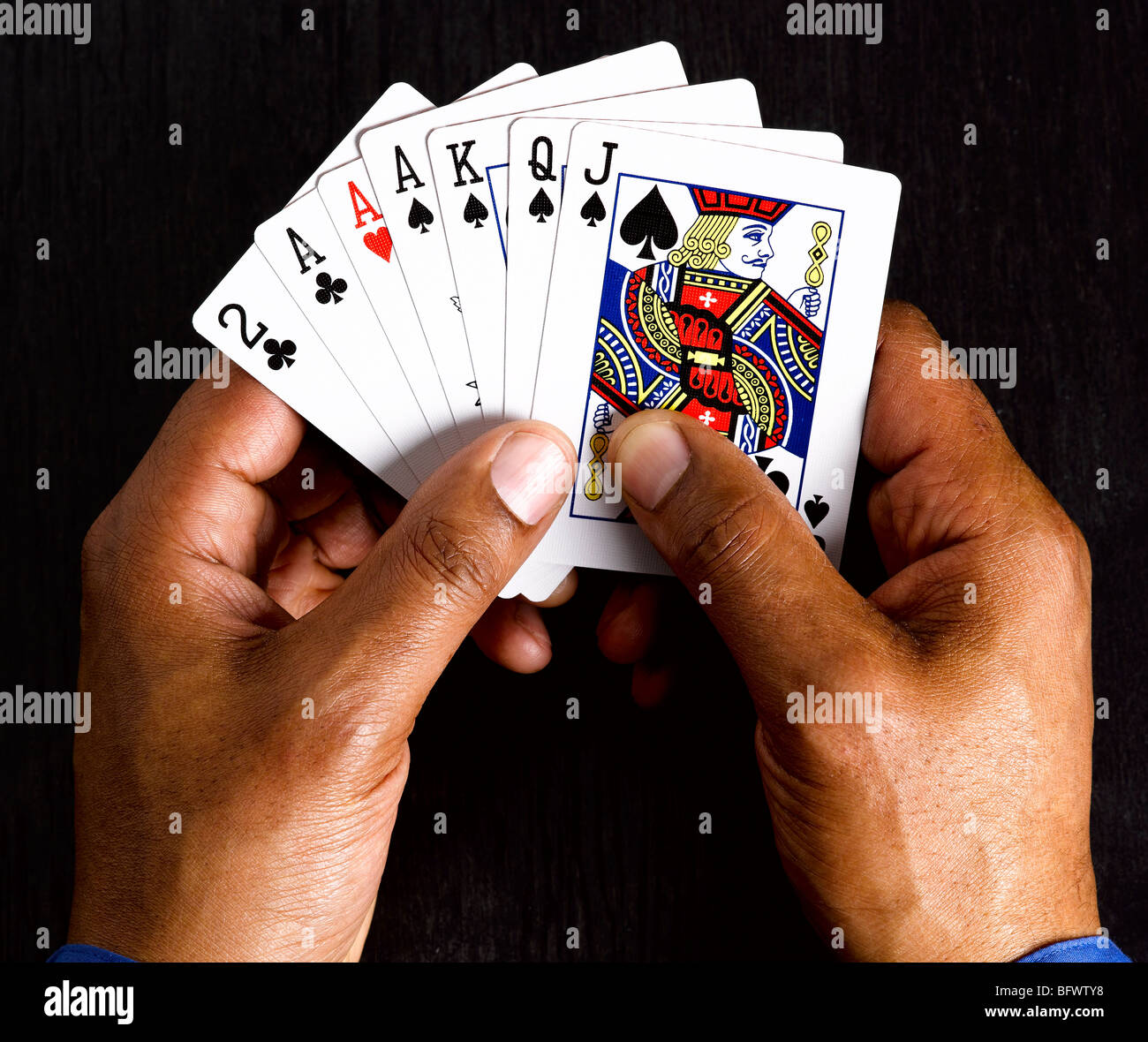 Business man with winning cards Stock Photo - Alamy