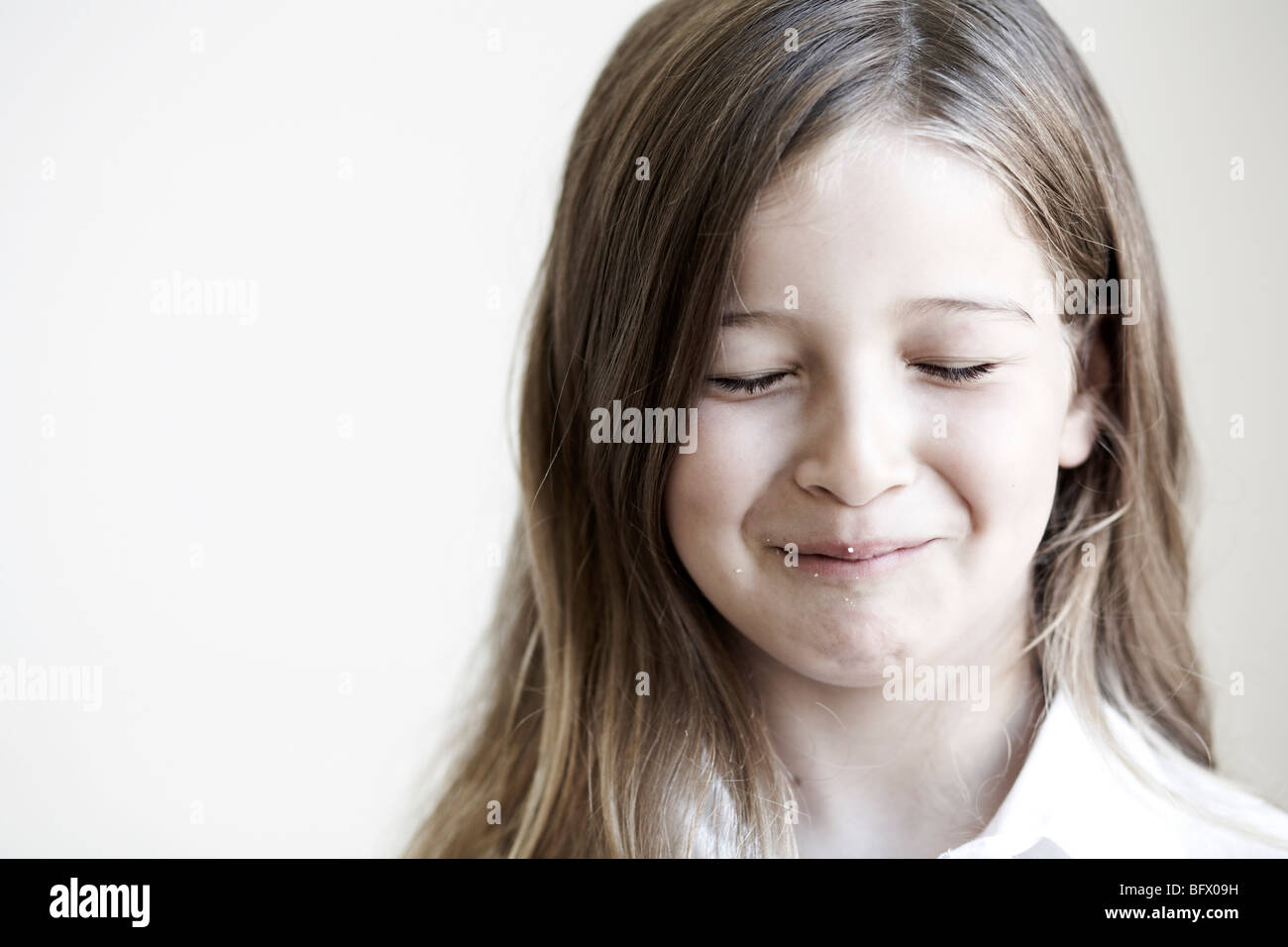 Young girl with crumbs on face Stock Photo - Alamy