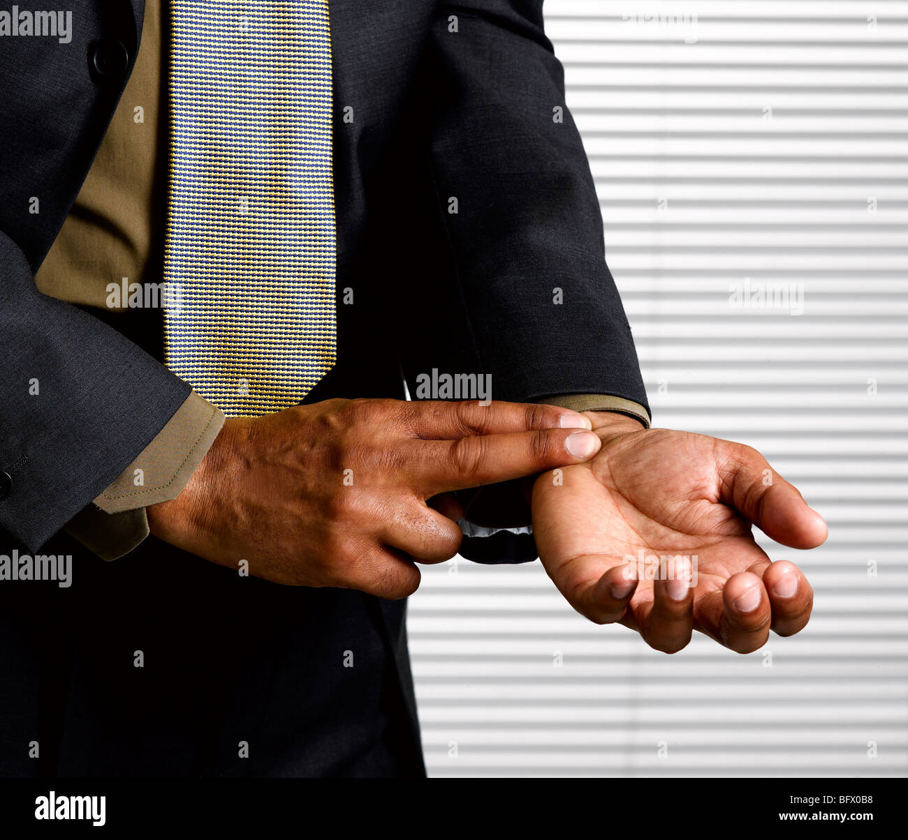 Business man with finger on pulse Stock Photo - Alamy