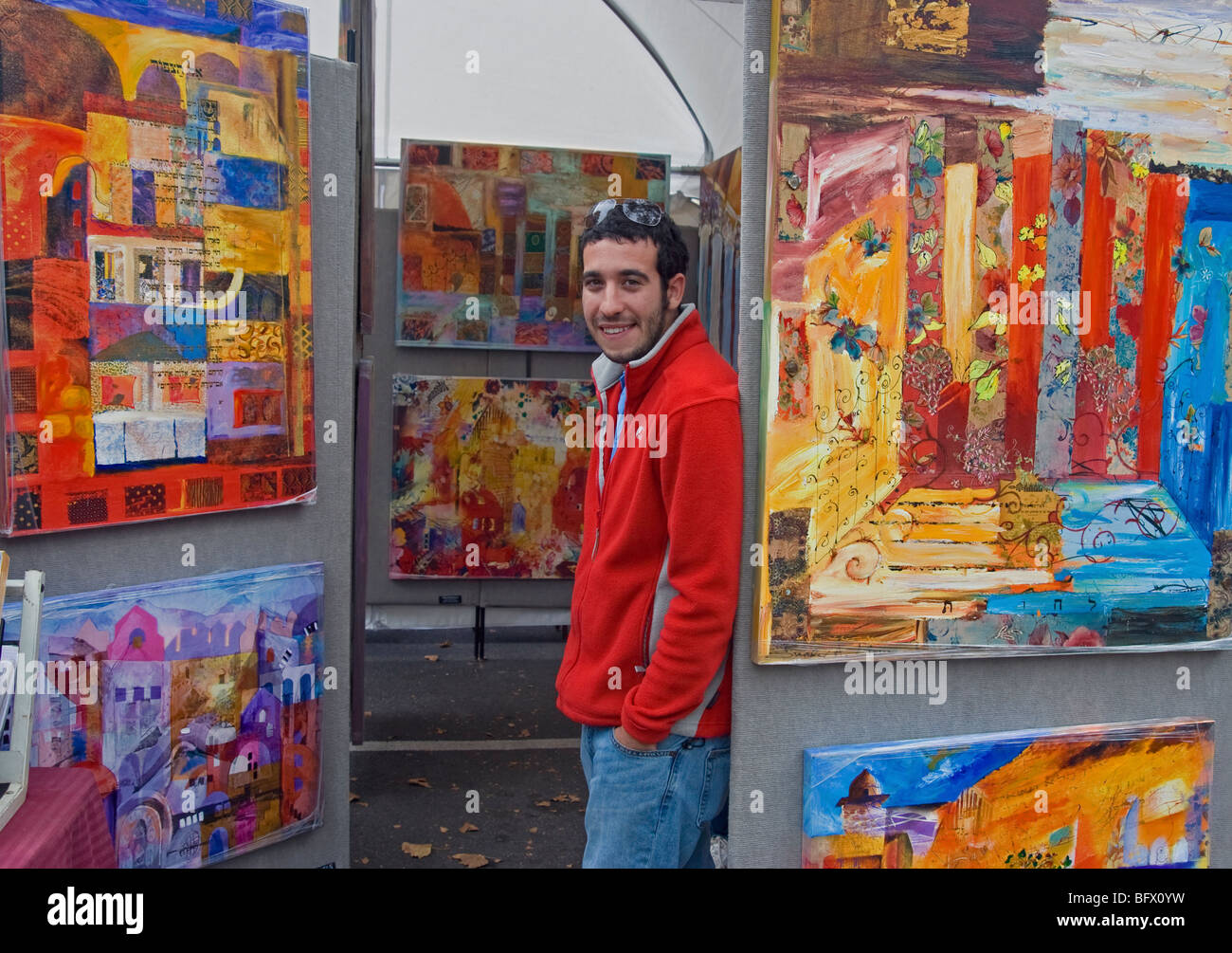 Artist selling paintings at an arts and crafts festival Stock Photo - Alamy
