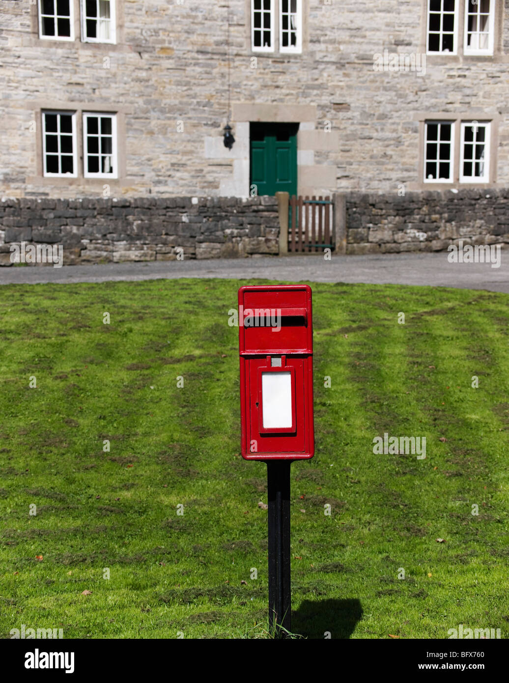 village with houses and red post box in countryside - tissington ...