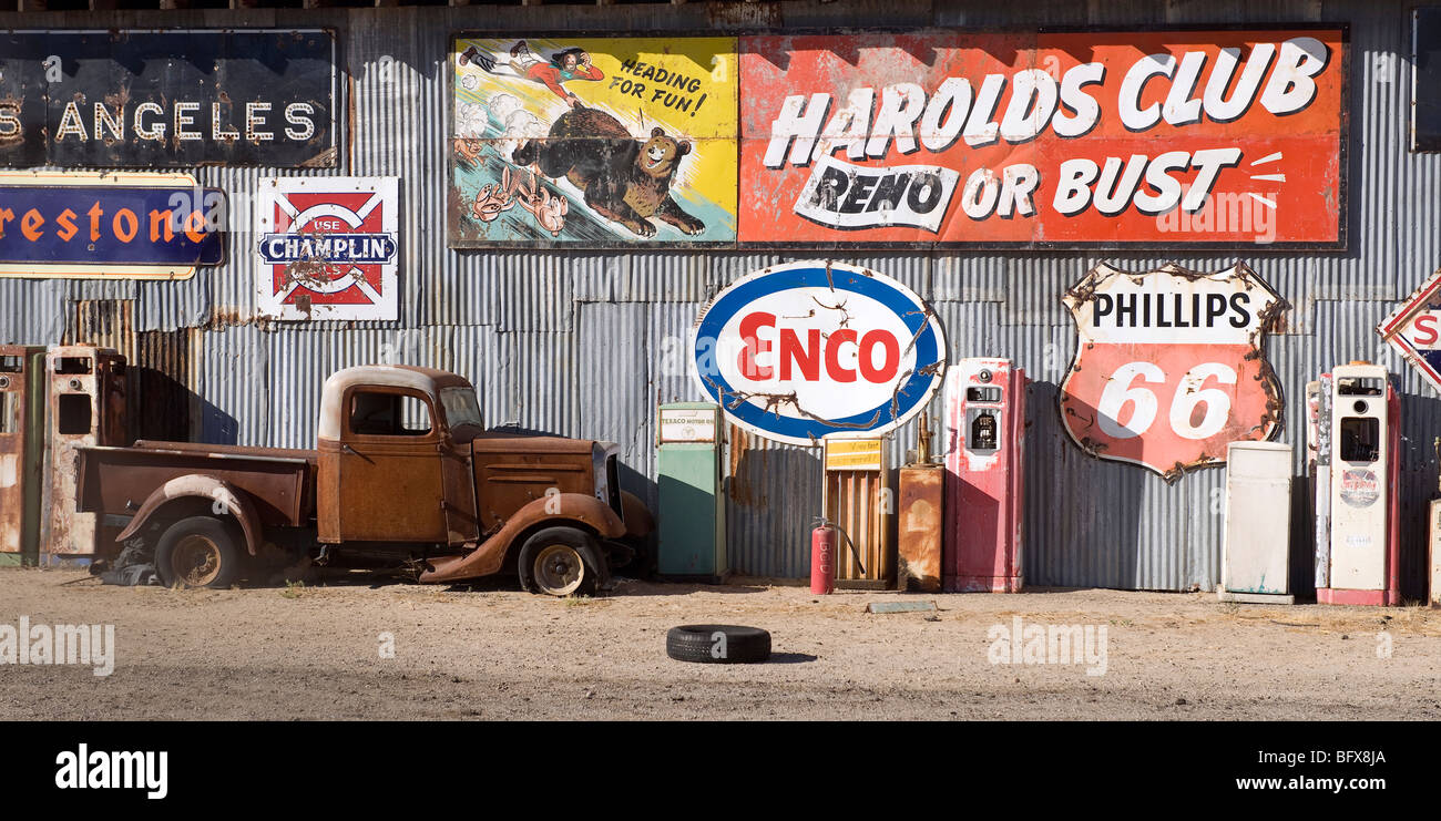 Junkyard with Old Oil Industry Signs and rusted car Stock Photo - Alamy