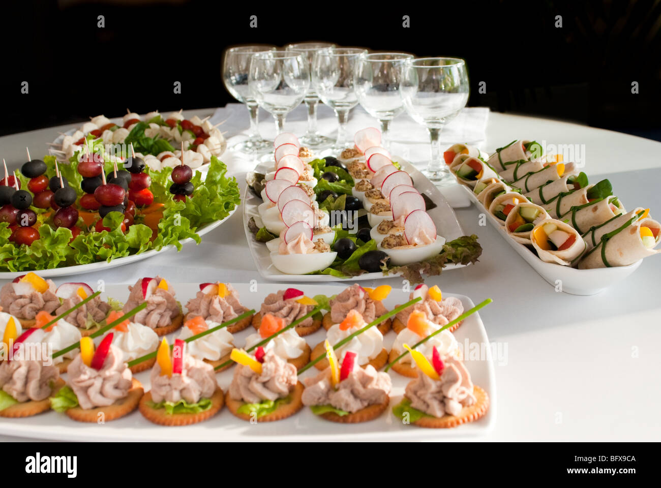 A selection of canapes on white dishes on a white tablecloth Stock ...