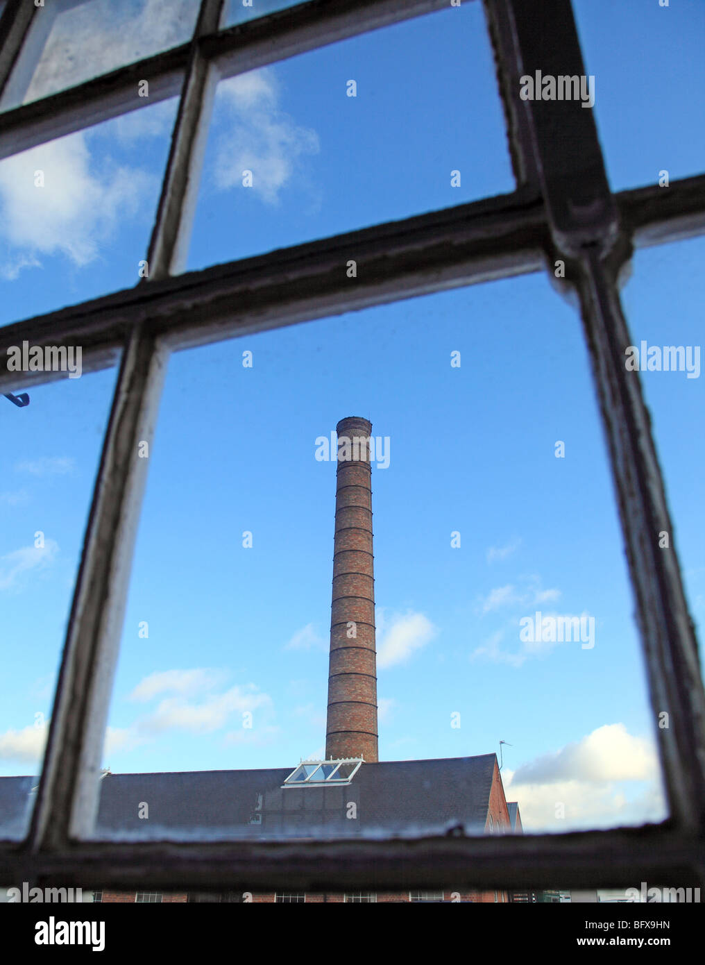 An industrial chimney seen through an old Victorian era window Stock ...