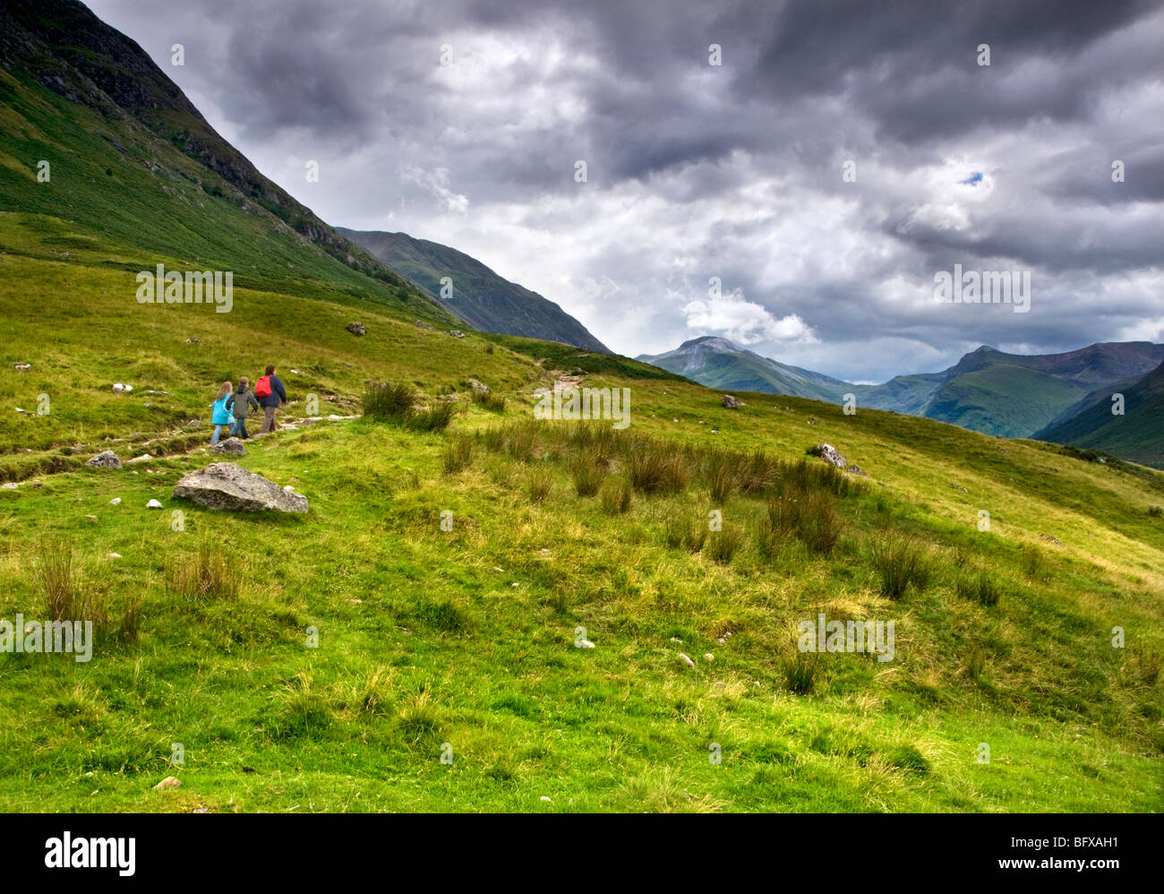 A family group making its way along the tourist path up Ben Nevis in ...