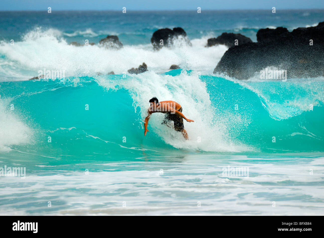 Catching Waves in Hawaii Stock Photo - Alamy