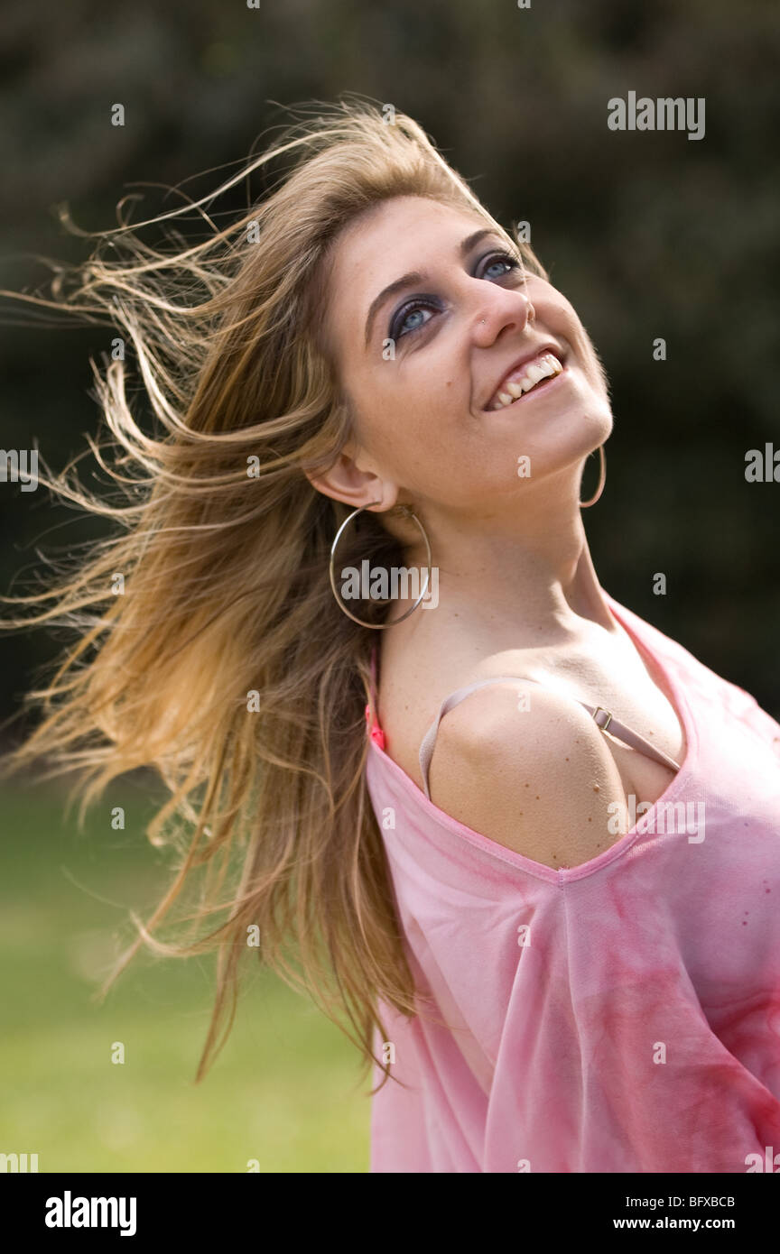 A young woman modeling at a park Stock Photo - Alamy
