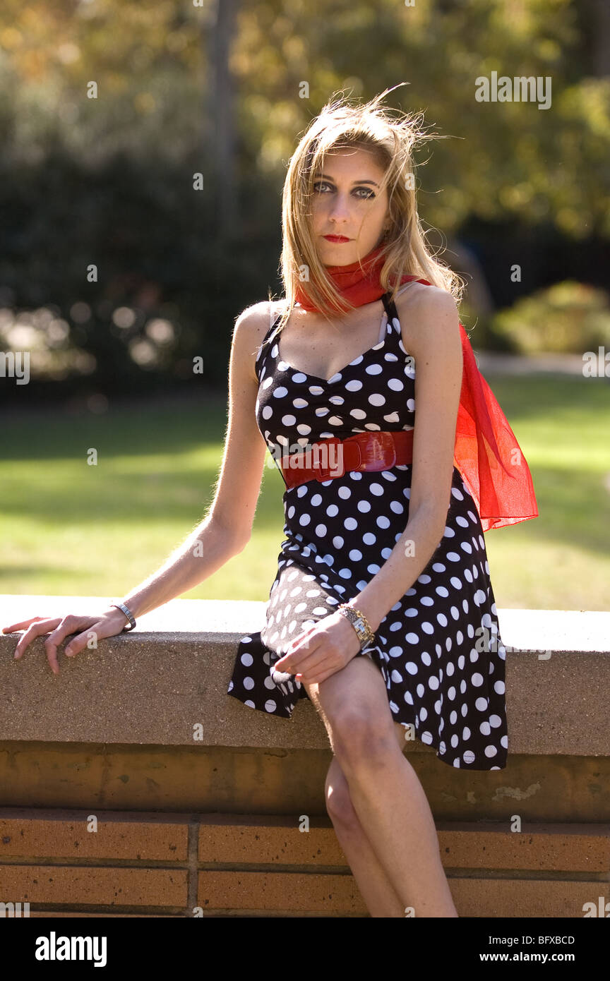 A young woman modeling at a park Stock Photo - Alamy