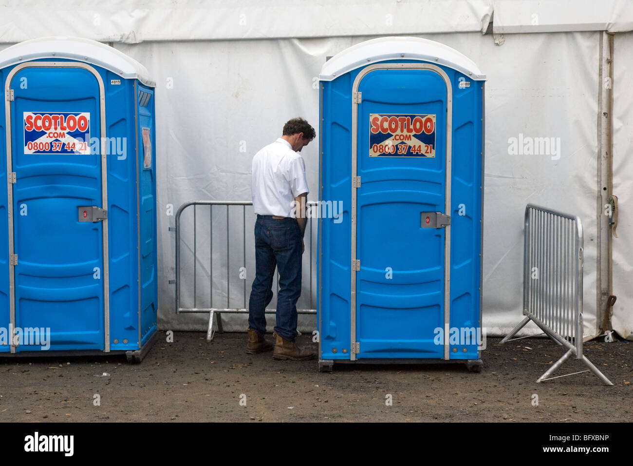 A Man Urinating Against A Stock Photo - Alamy