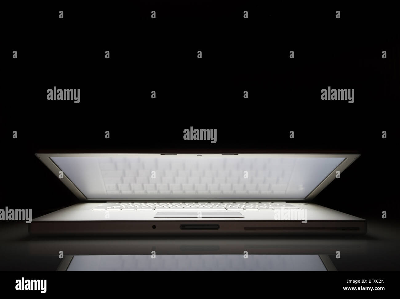 Silver laptop in the dark with copy space Stock Photo - Alamy