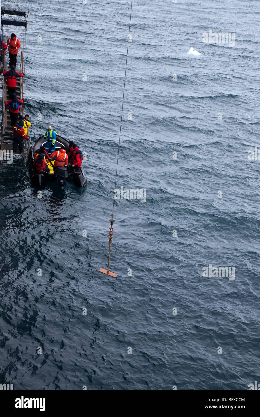 Expedition Cruise ship passengers unloading from zodiac, Paradise Bay ...