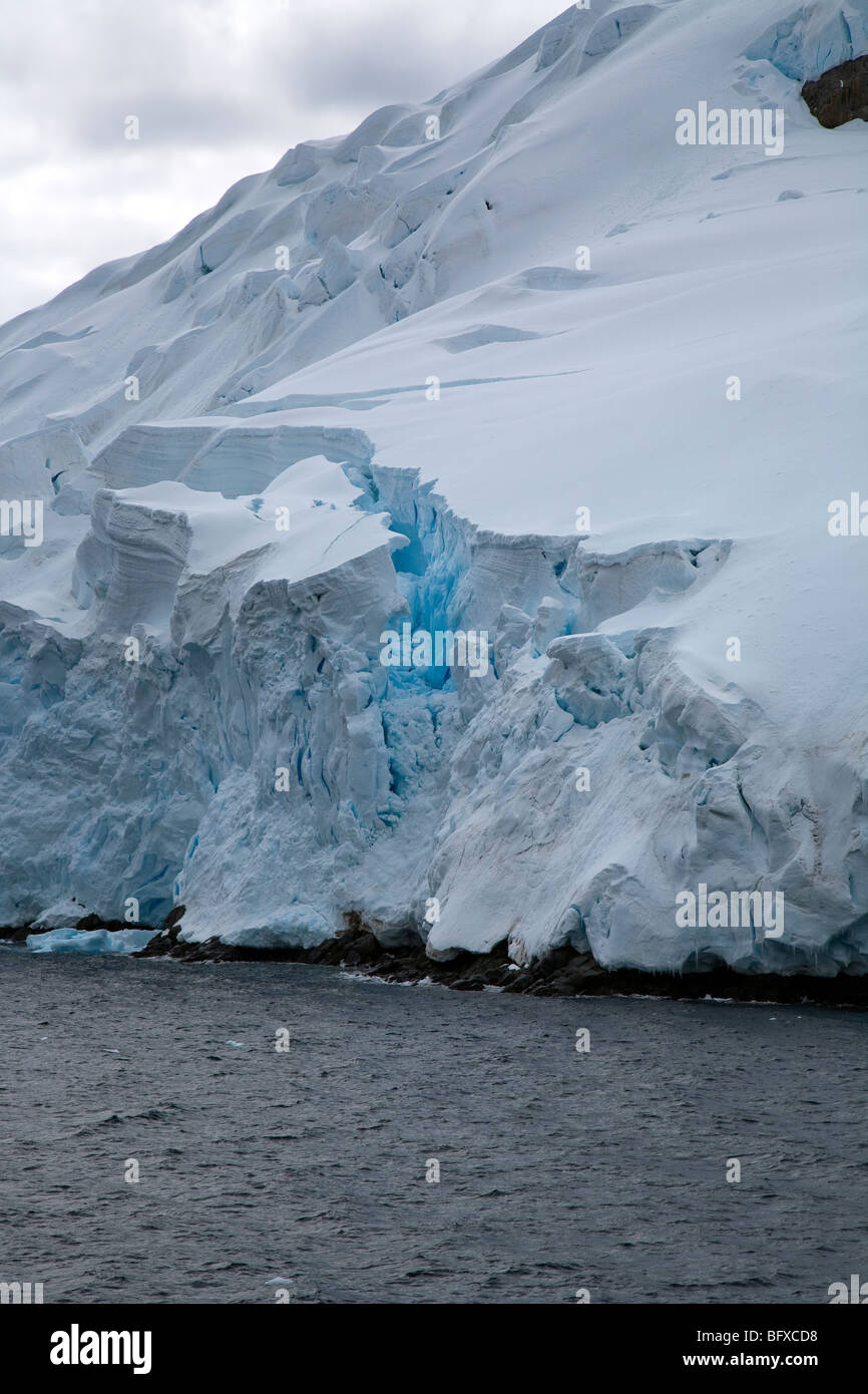 Large chasm in the ice cap extending to the waterline, Paradise Bay ...