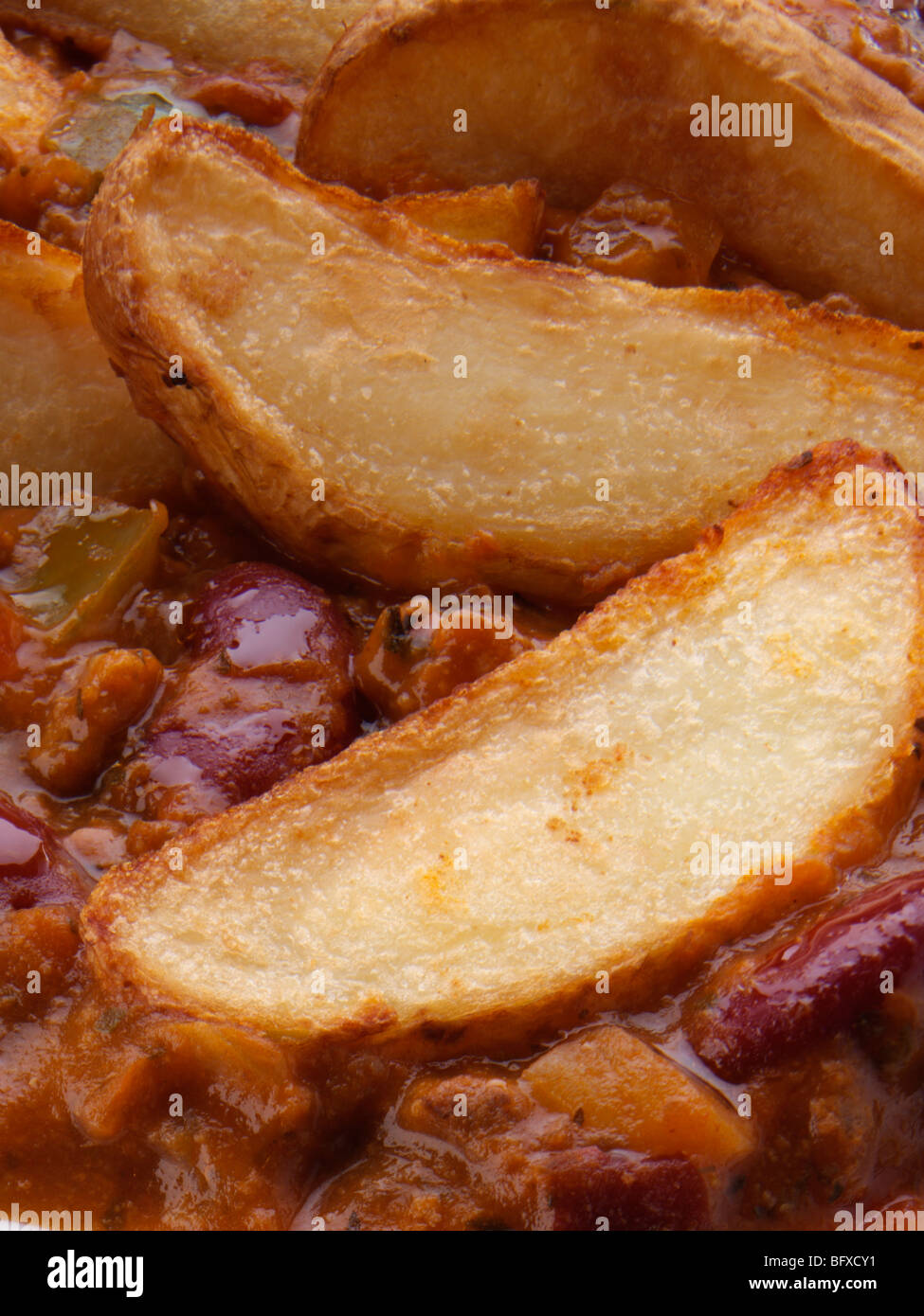 Chilli con carne and potato wedges close up Stock Photo - Alamy