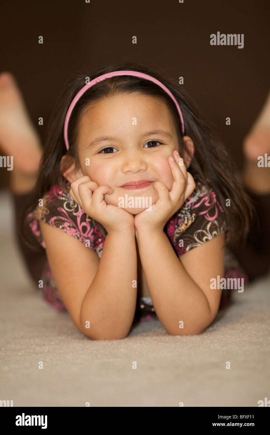 Four year old girl posing on floor Stock Photo - Alamy