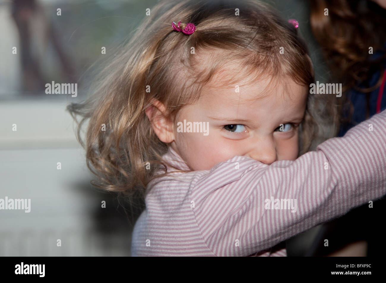 Girl scowling at camera Stock Photo - Alamy