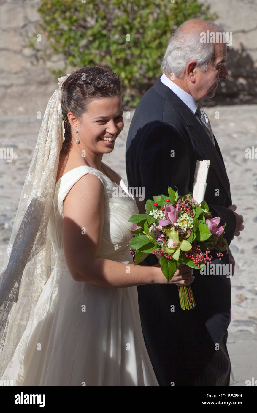 Spanish bride walking with her father into church, Granada, Andalusia ...