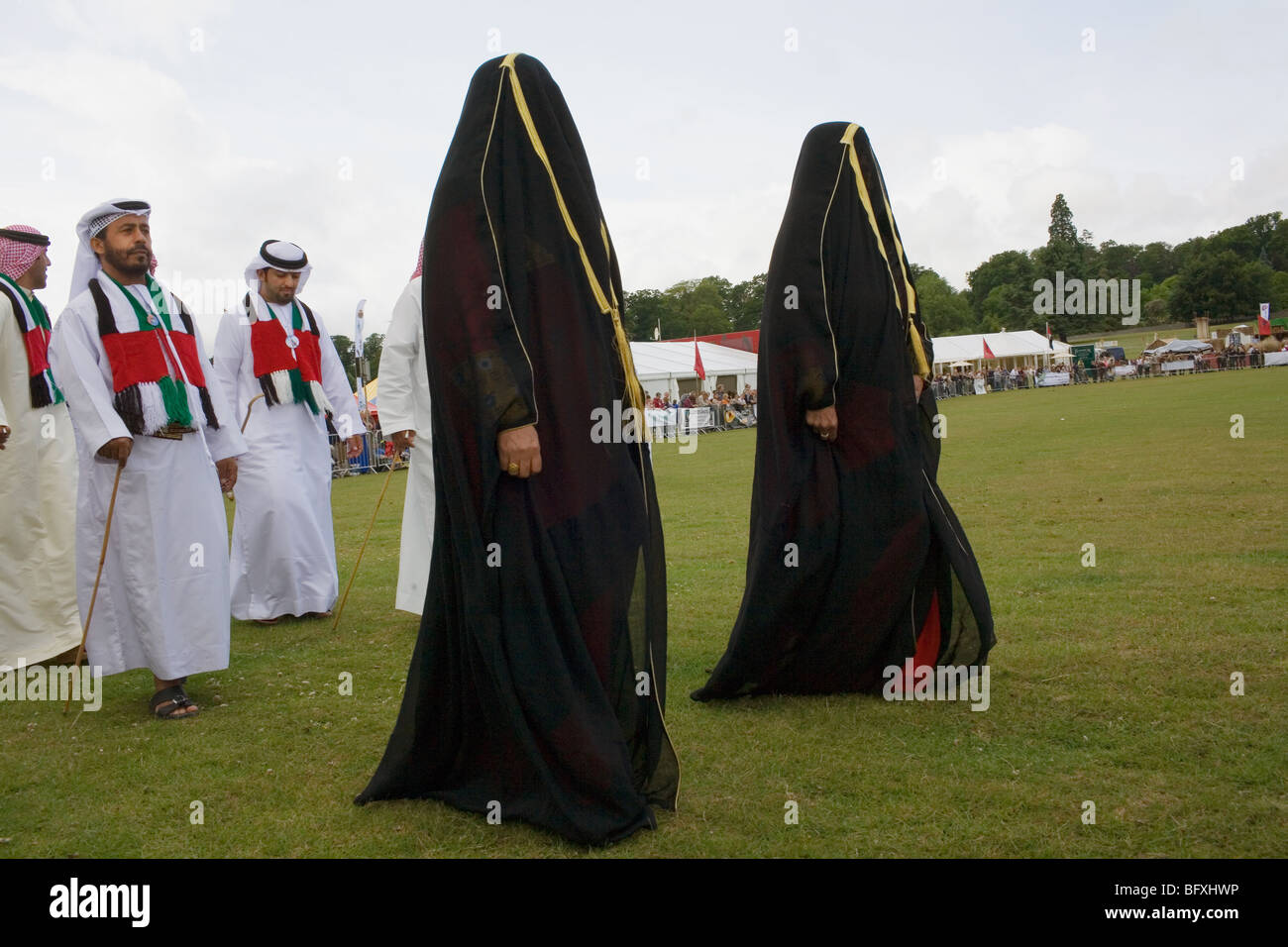 2 women representing the Abu Dhabi hawk board dressed head to toe in a ...