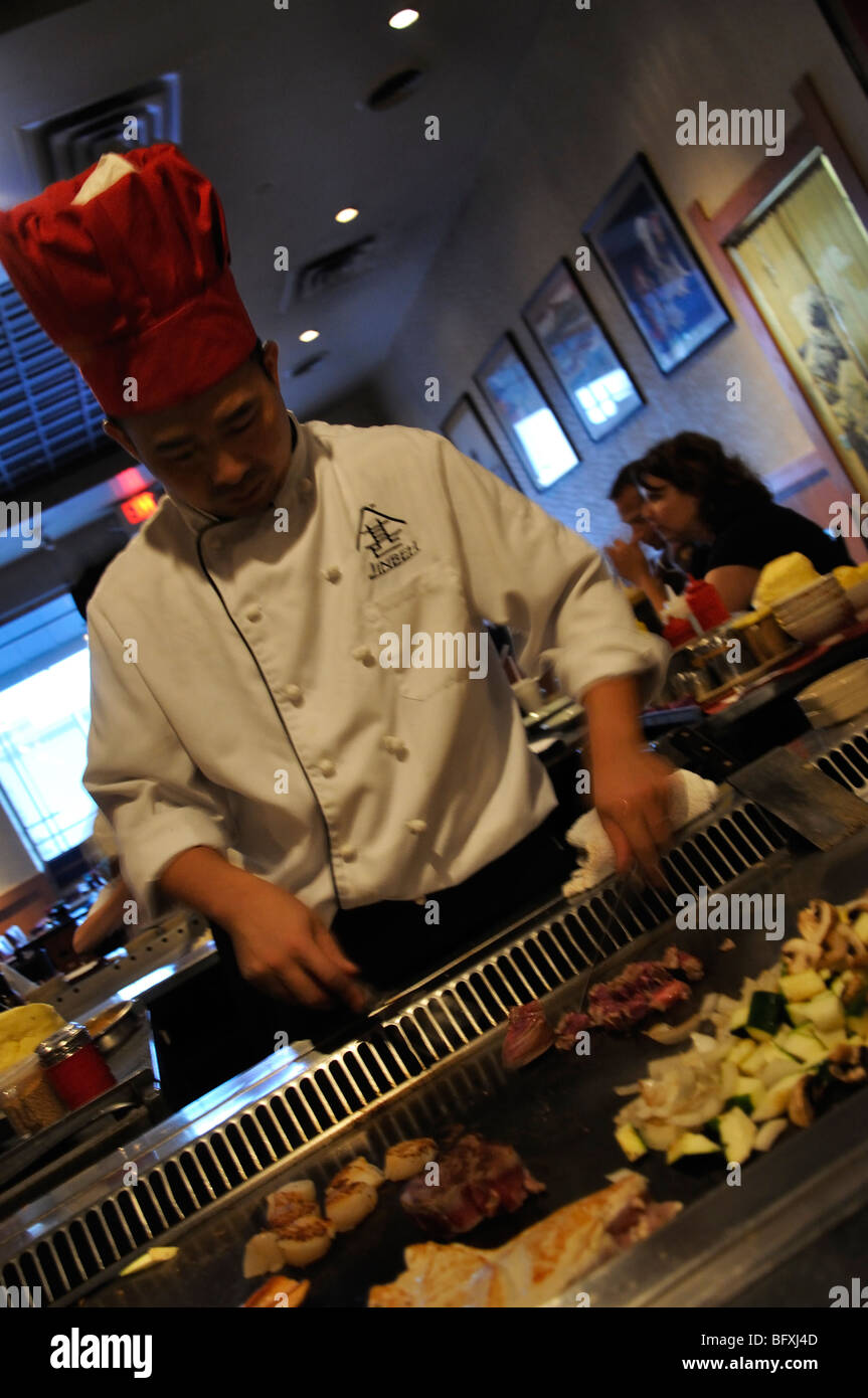 Chef cooking food on a grill at Japanese restaurant Stock Photo - Alamy