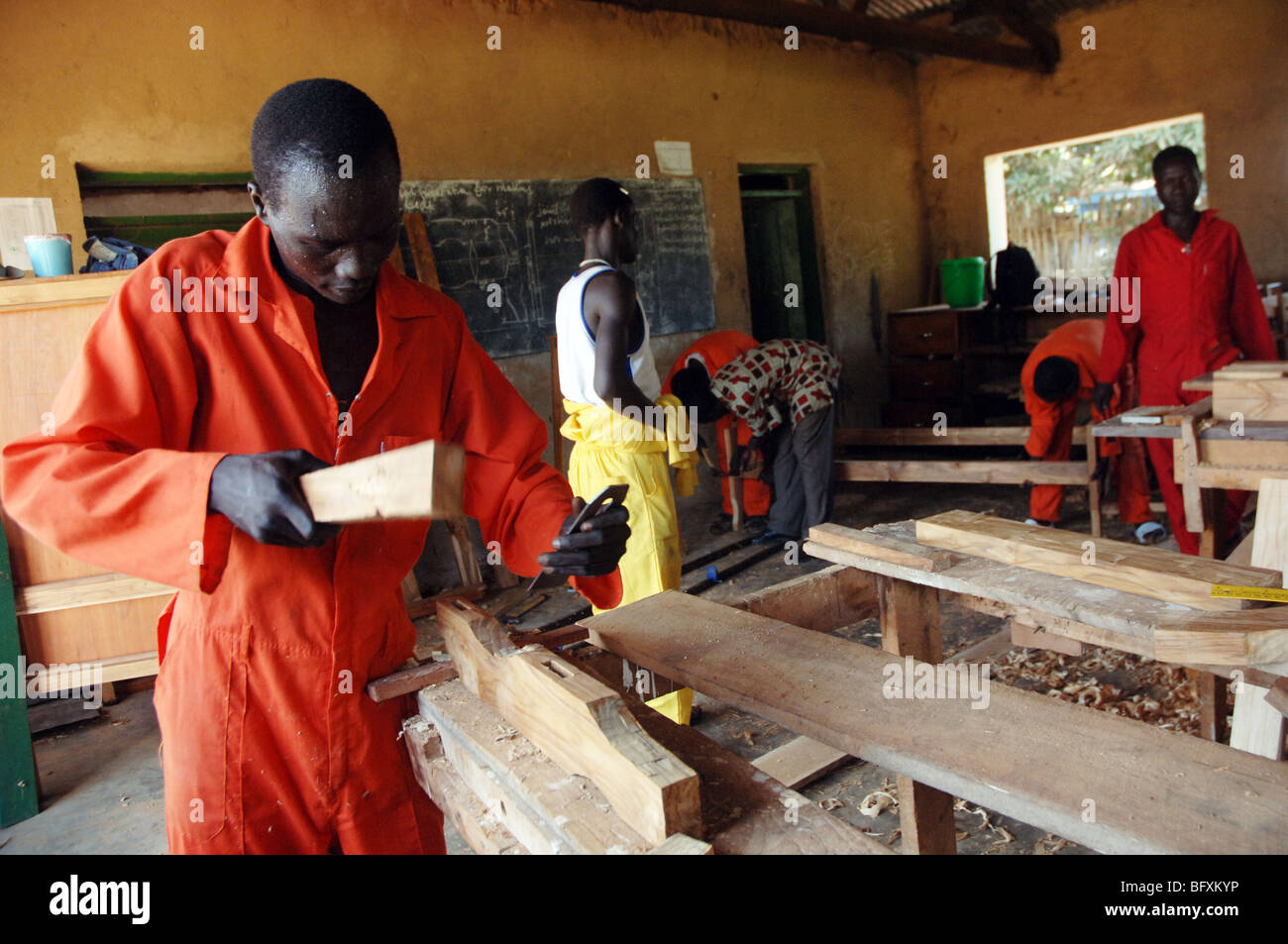 Sudanese men learning carpentry at a Vocational Training Centre in Yei ...