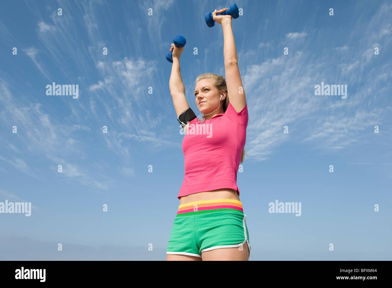 Young woman lifting hand weights Stock Photo - Alamy