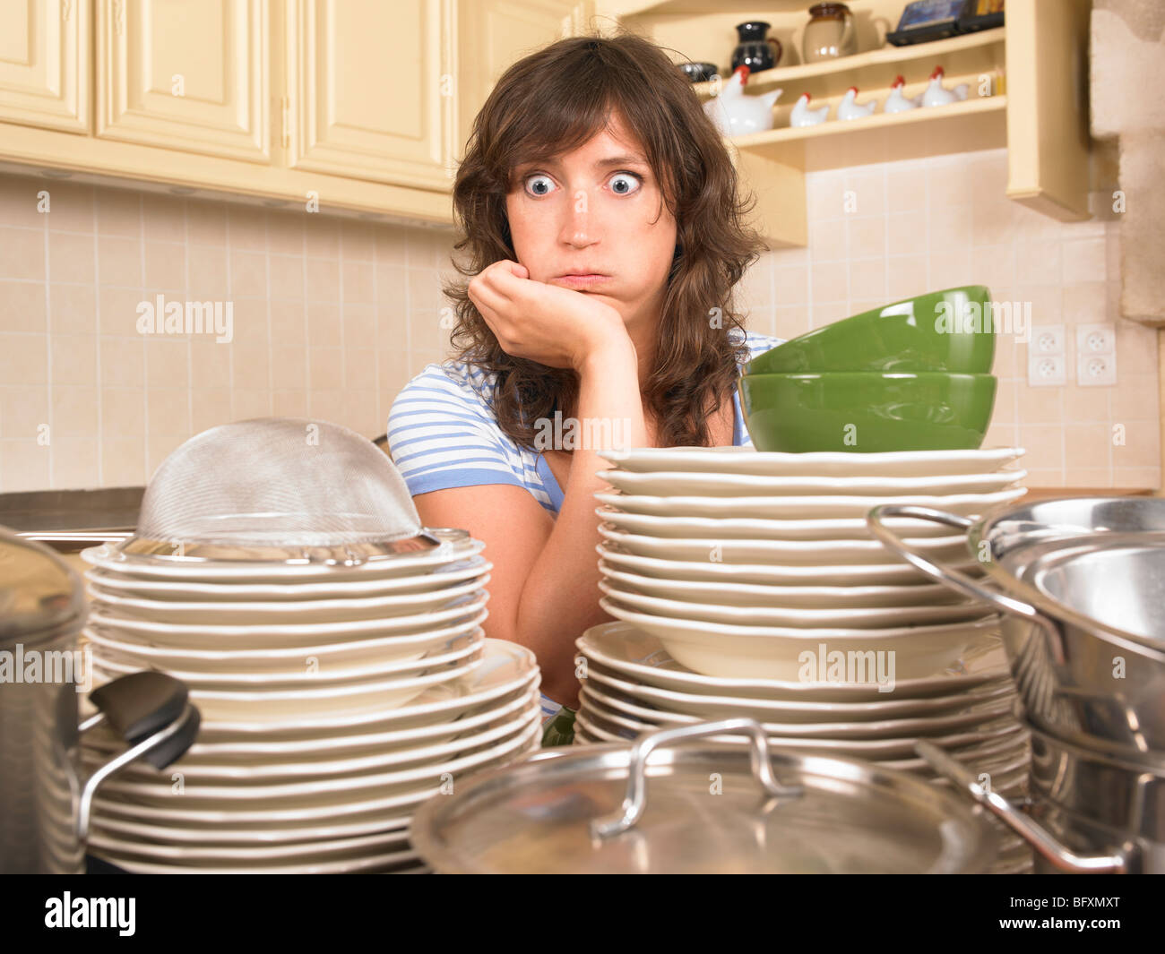 woman with piles of washing up Stock Photo - Alamy