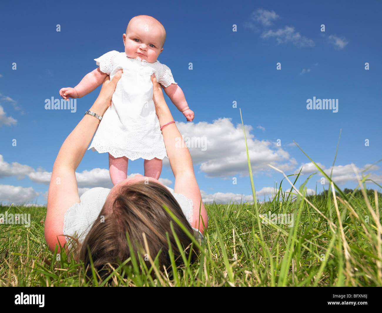 mother and baby in field Stock Photo - Alamy