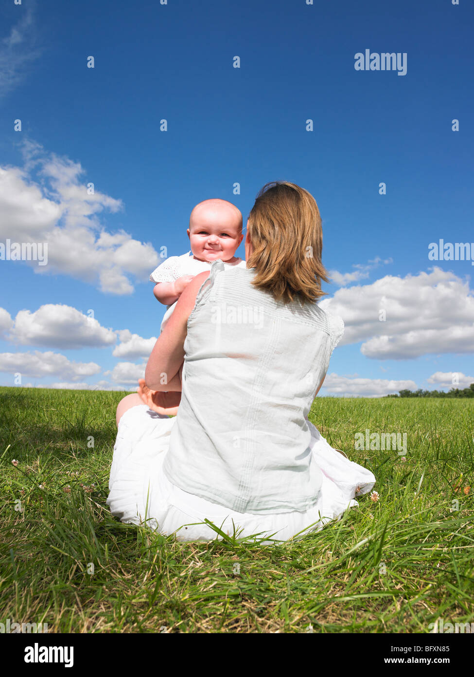 mother and baby in field Stock Photo - Alamy