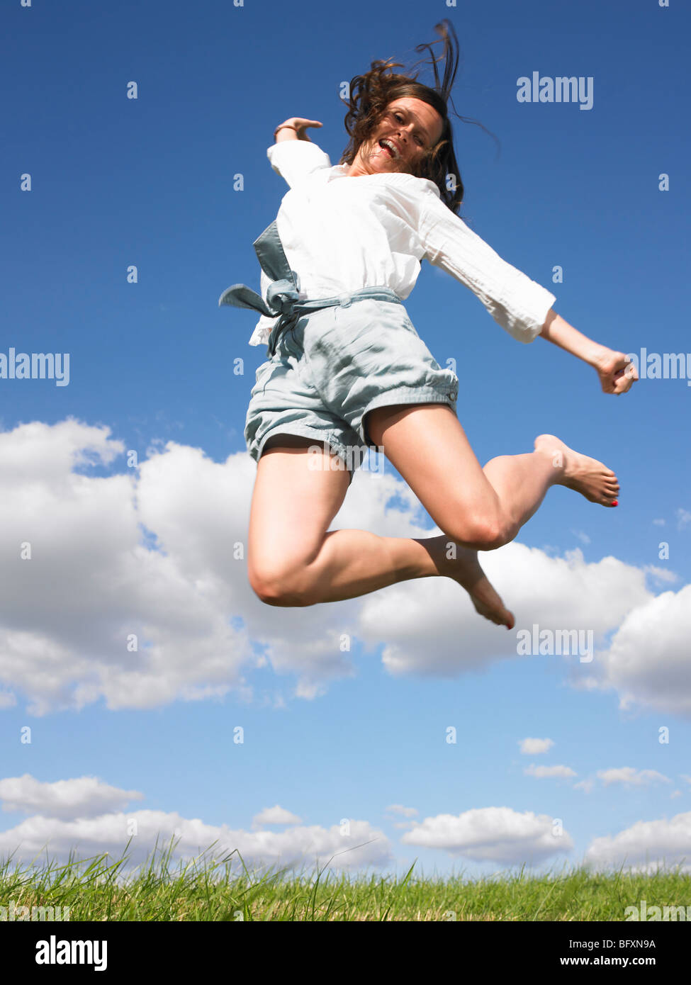 young woman jumping Stock Photo - Alamy