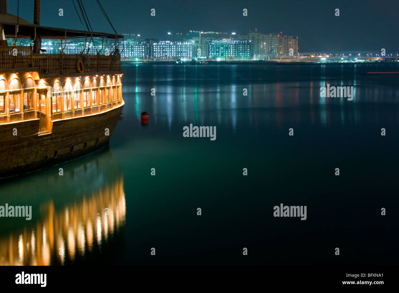 Dubai - Dhow Lights reflection and Palm construction Stock Photo - Alamy