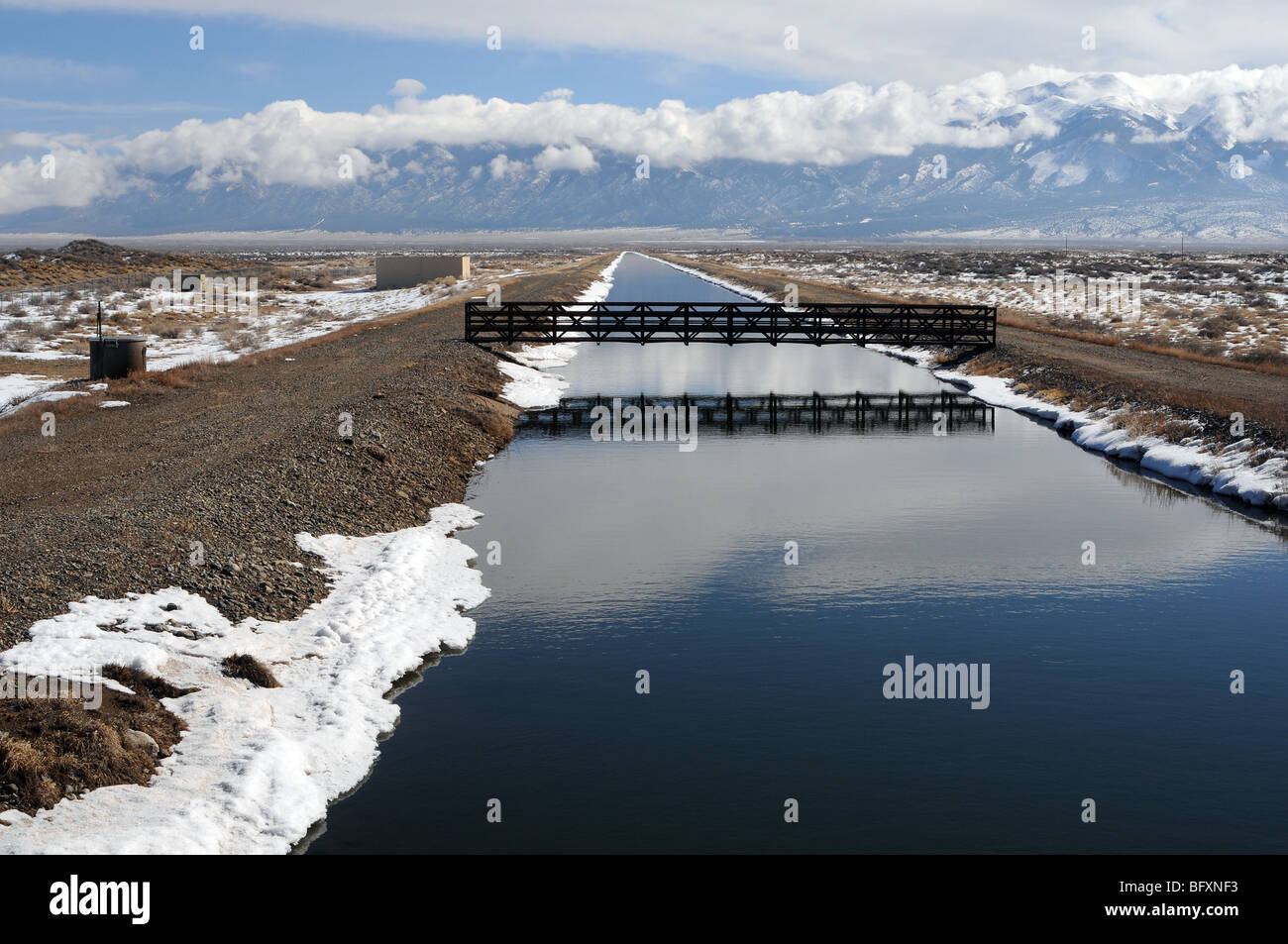 Bridge over a Creek and Sangre de Cristo Mountains on the background ...