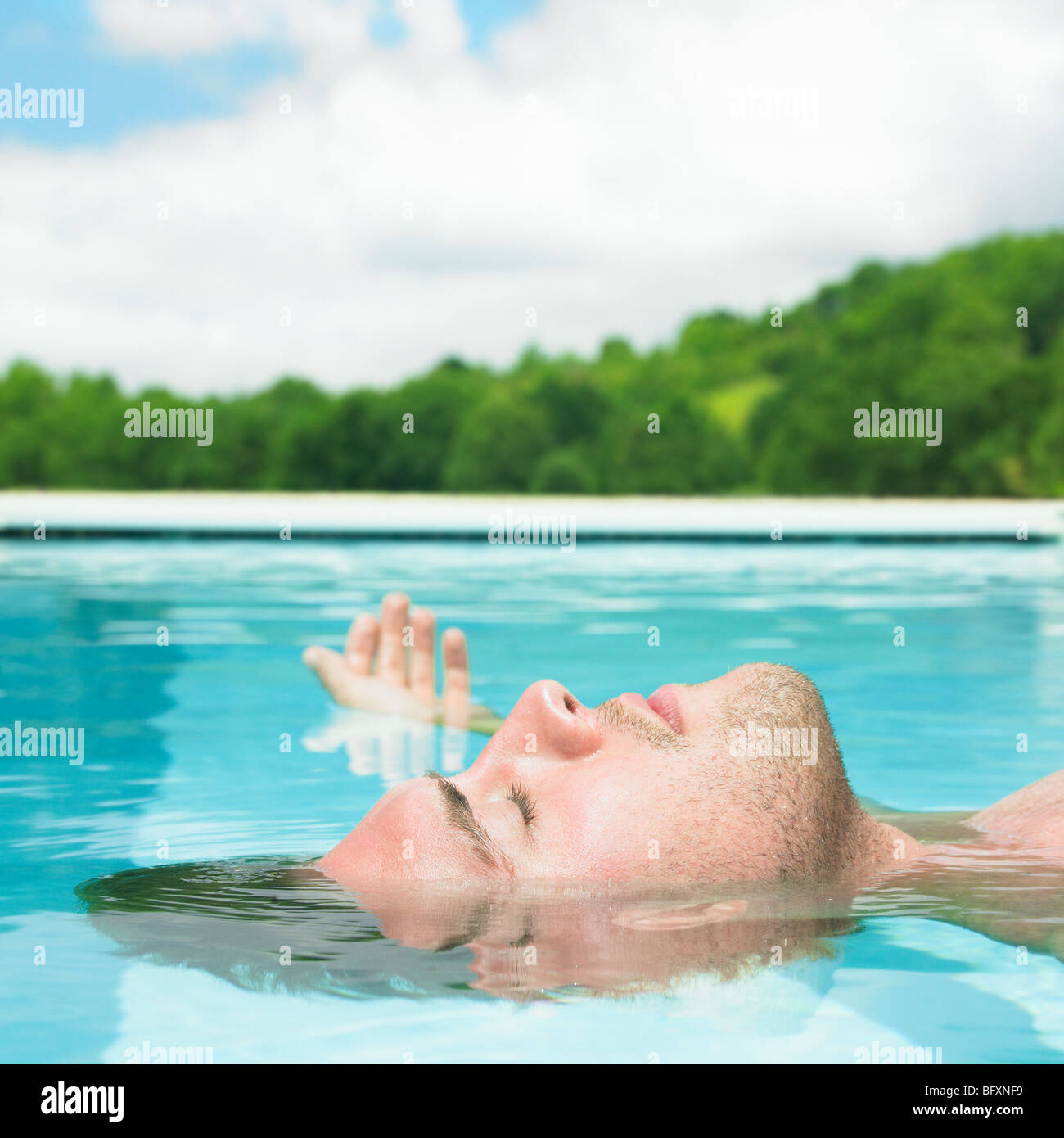 young man floating in water Stock Photo - Alamy