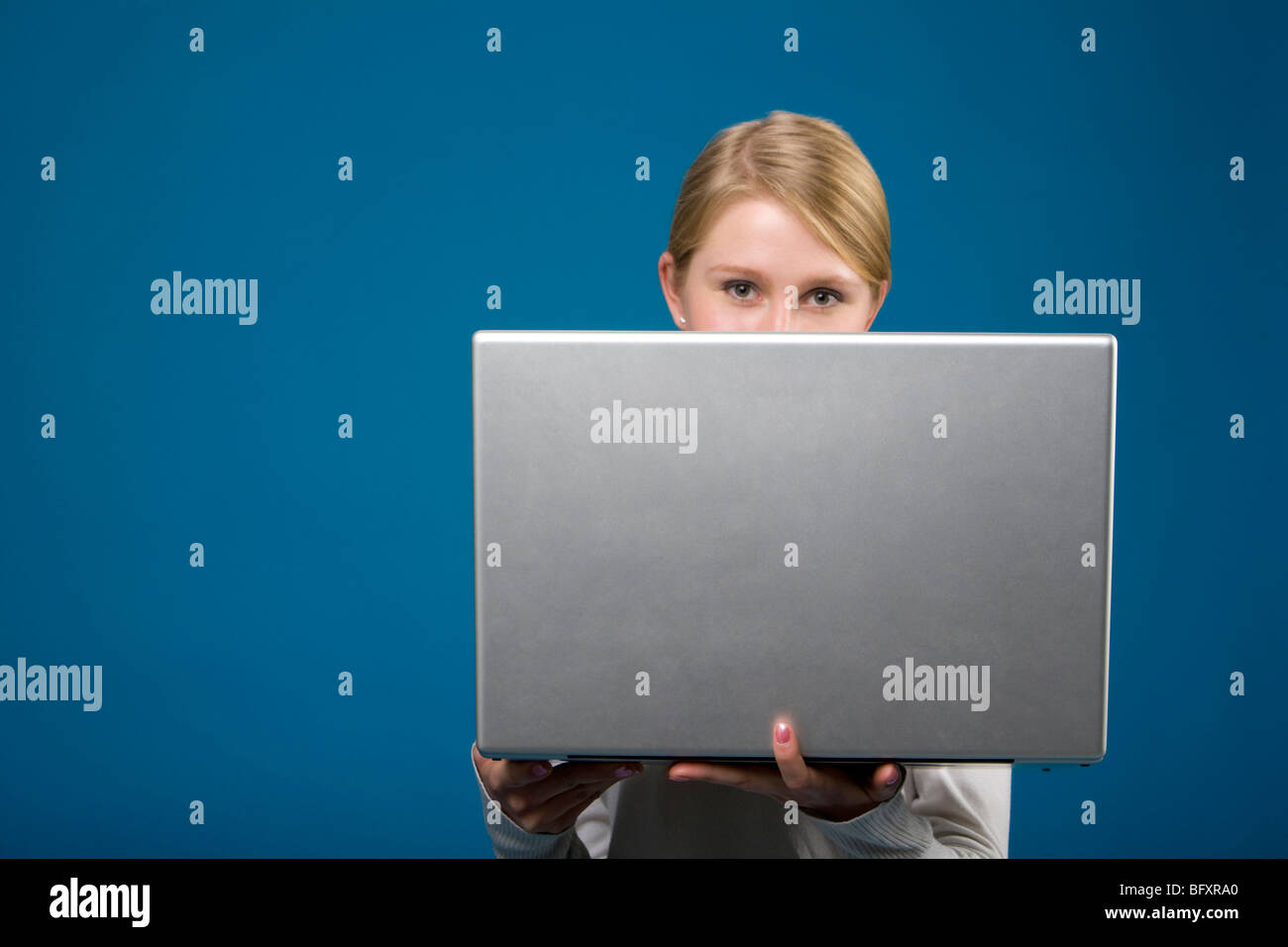 Person holding laptop in front of face hi-res stock photography and ...