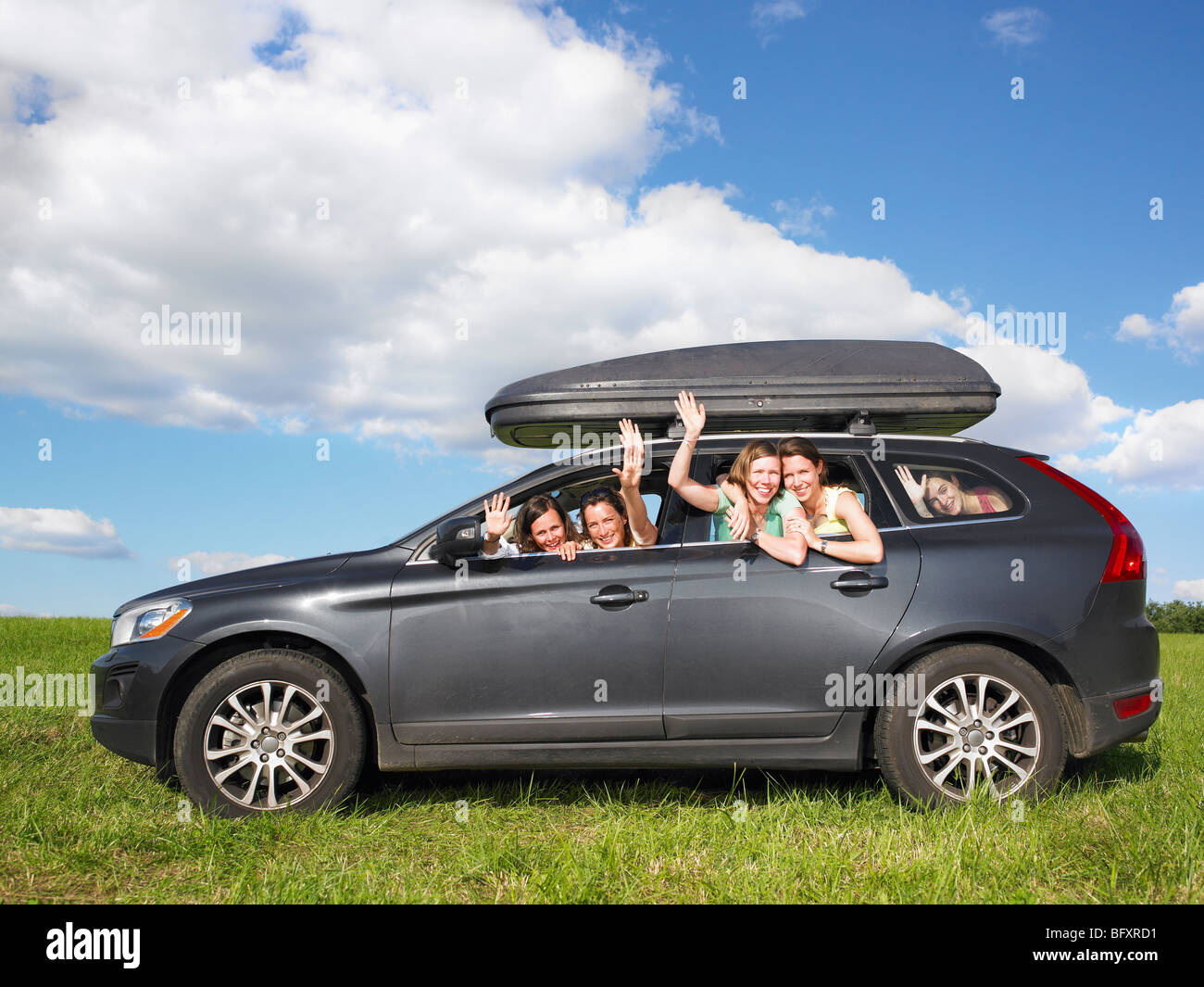 girls waving out of car windows Stock Photo - Alamy