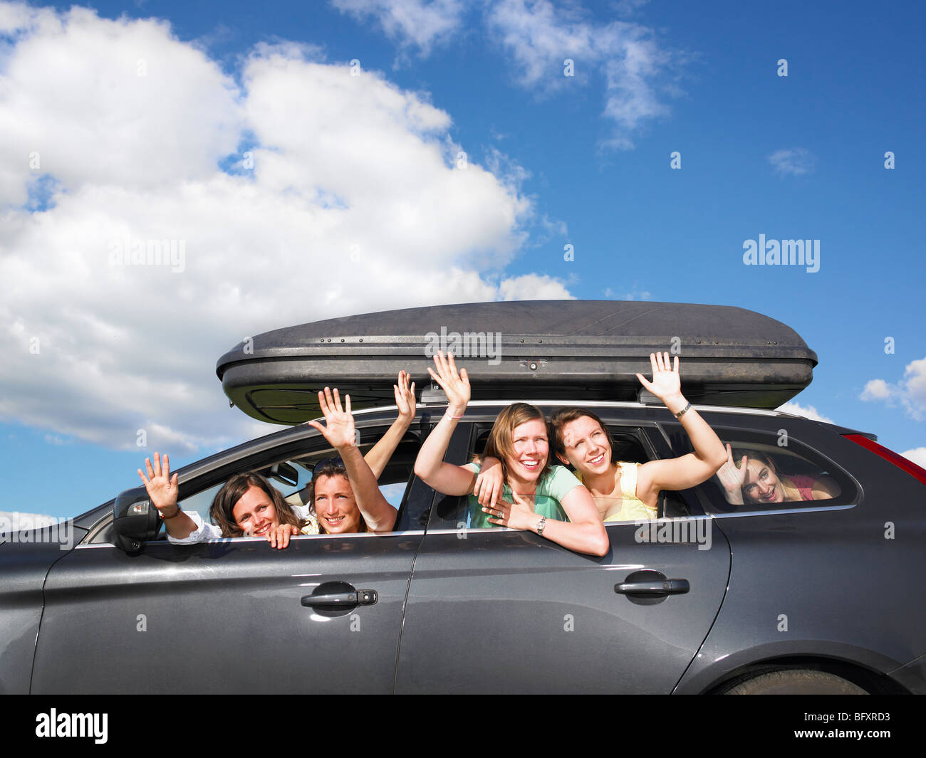 girls waving out of car windows Stock Photo - Alamy