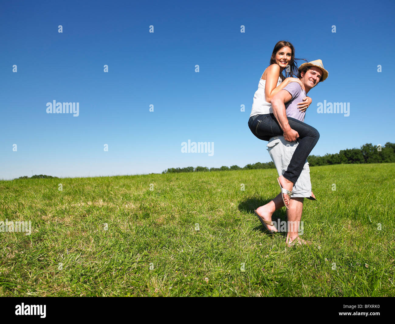 young people riding piggy back Stock Photo - Alamy