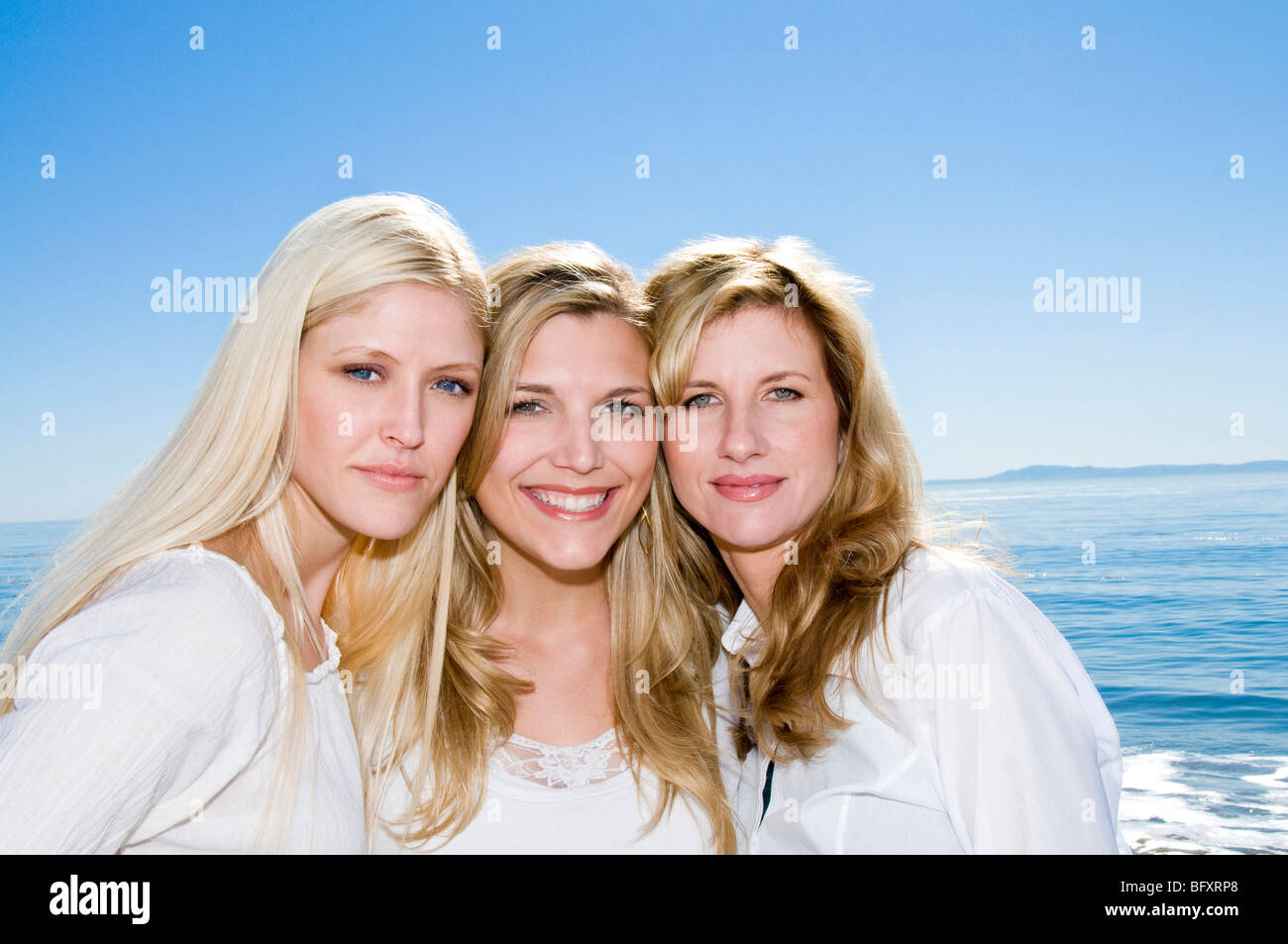Women smiling on beach Stock Photo - Alamy