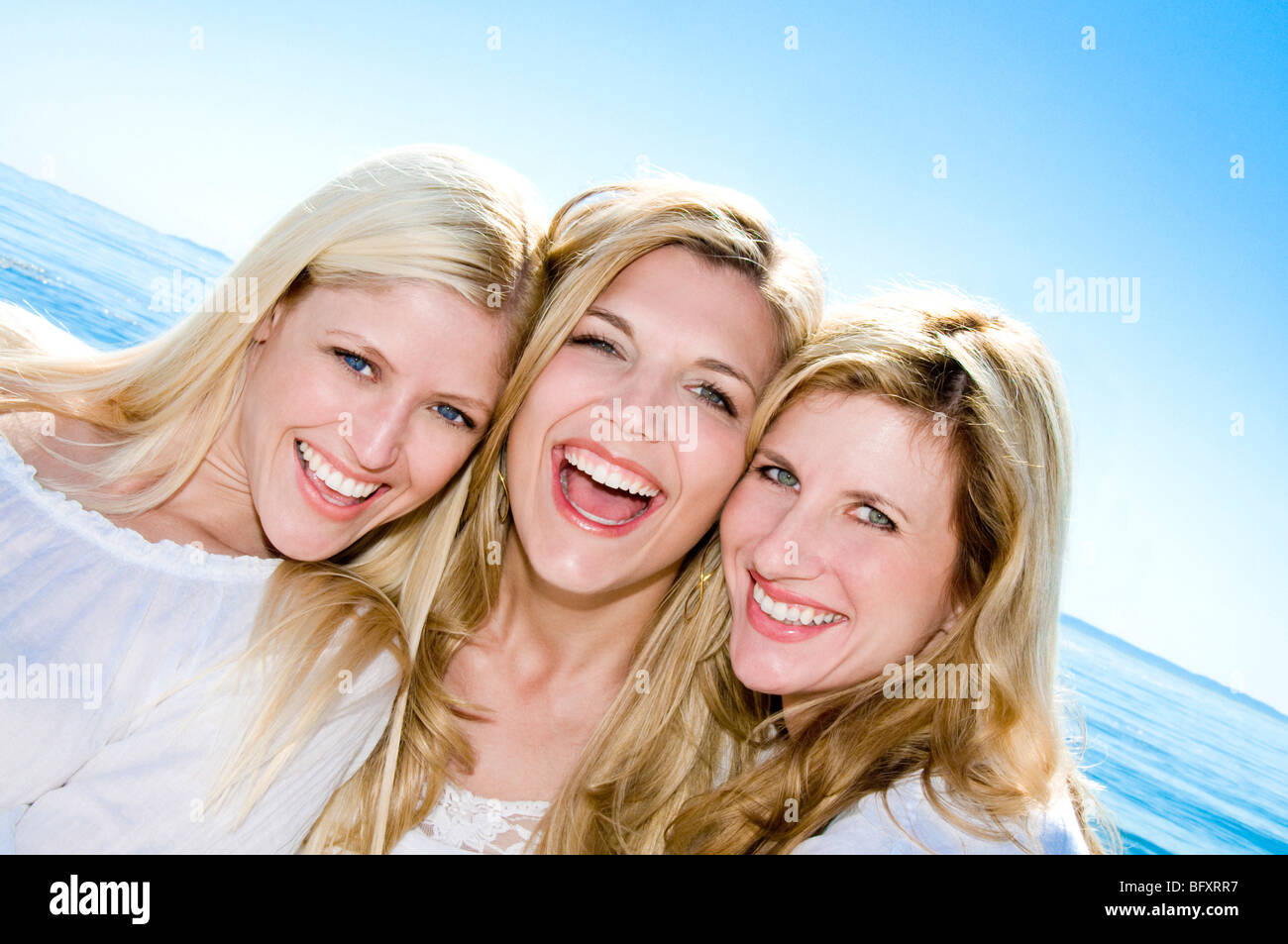 Women smiling on beach Stock Photo - Alamy