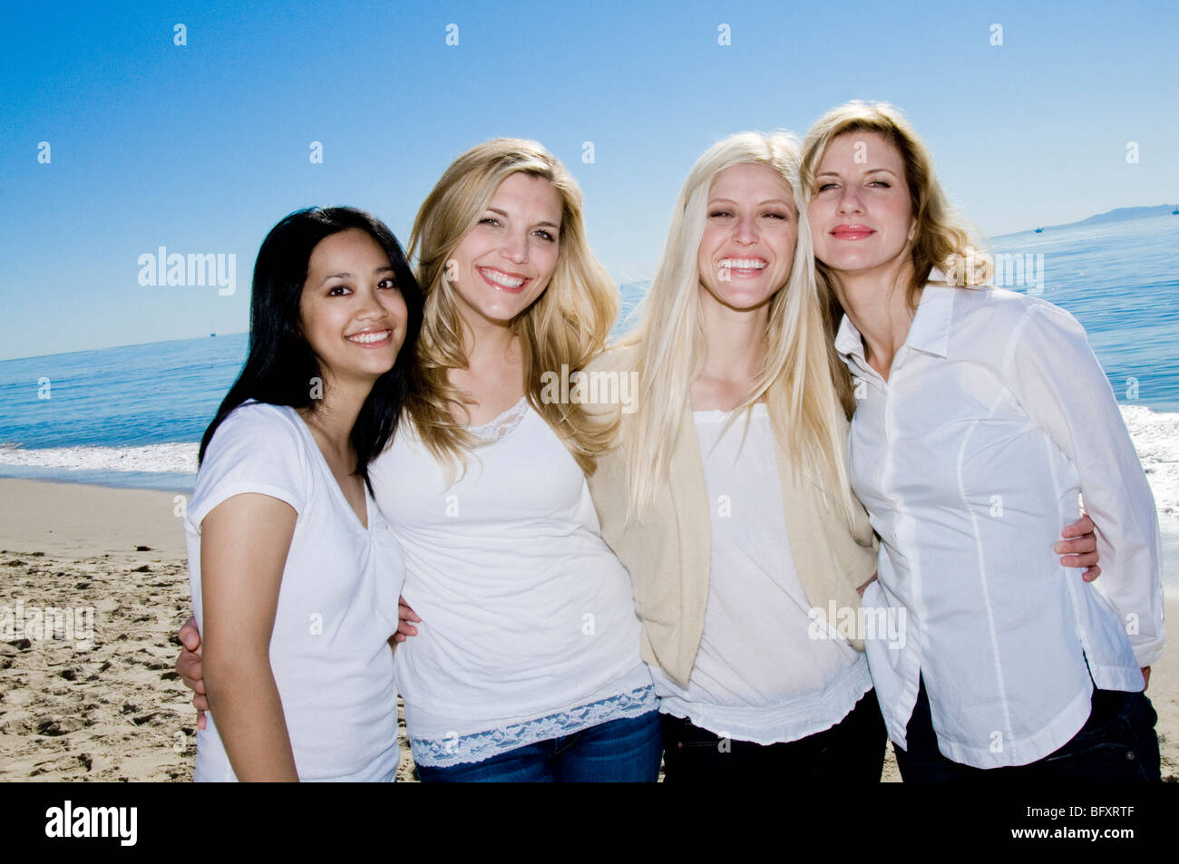 Women smiling on beach Stock Photo - Alamy