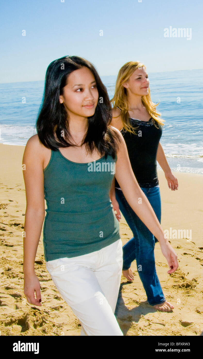 Women walking on beach Stock Photo - Alamy