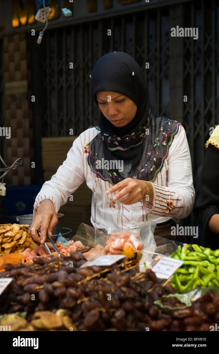 Muslim woman is selling dried fruit, Bangkok, Thailand Stock Photo - Alamy