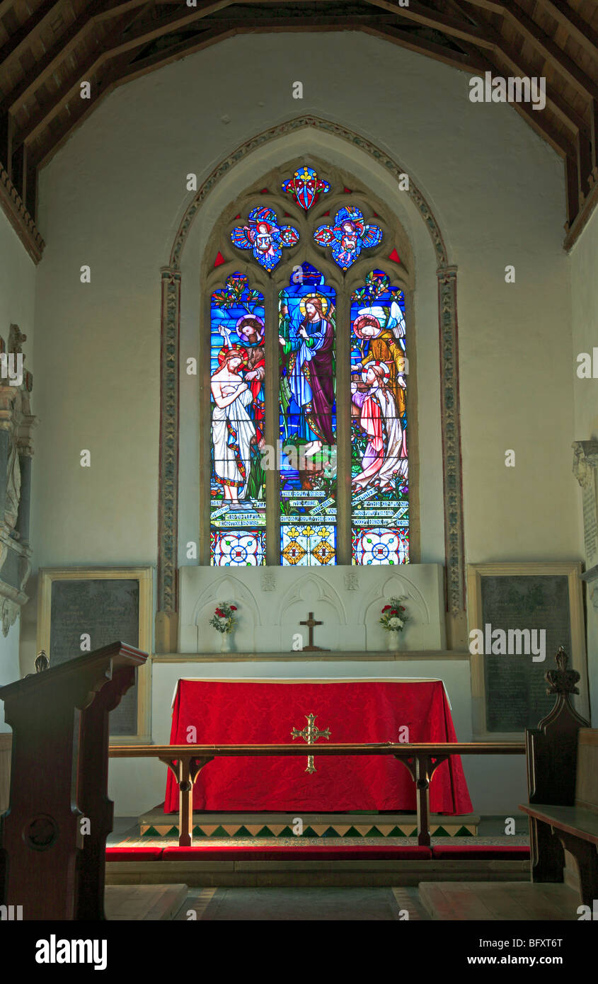 Stained glass window and altar in the Church of All Saints at Woodton ...