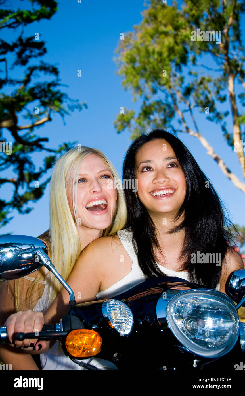 Women riding scooter Stock Photo - Alamy