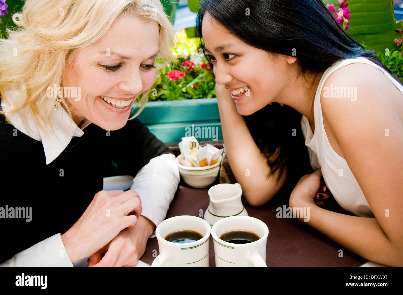 Women gossiping at cafe Stock Photo - Alamy