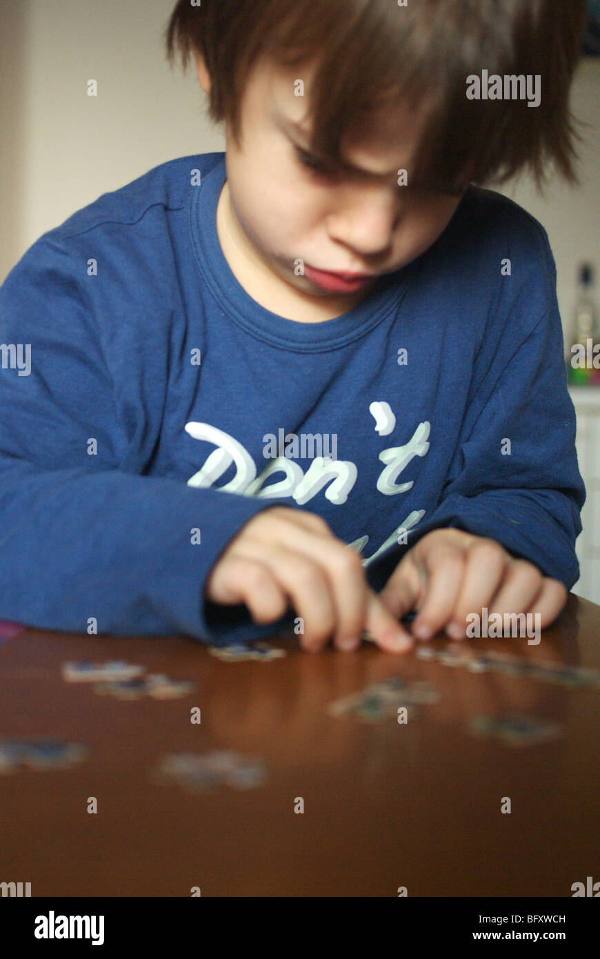 child makes a puzzle Stock Photo - Alamy