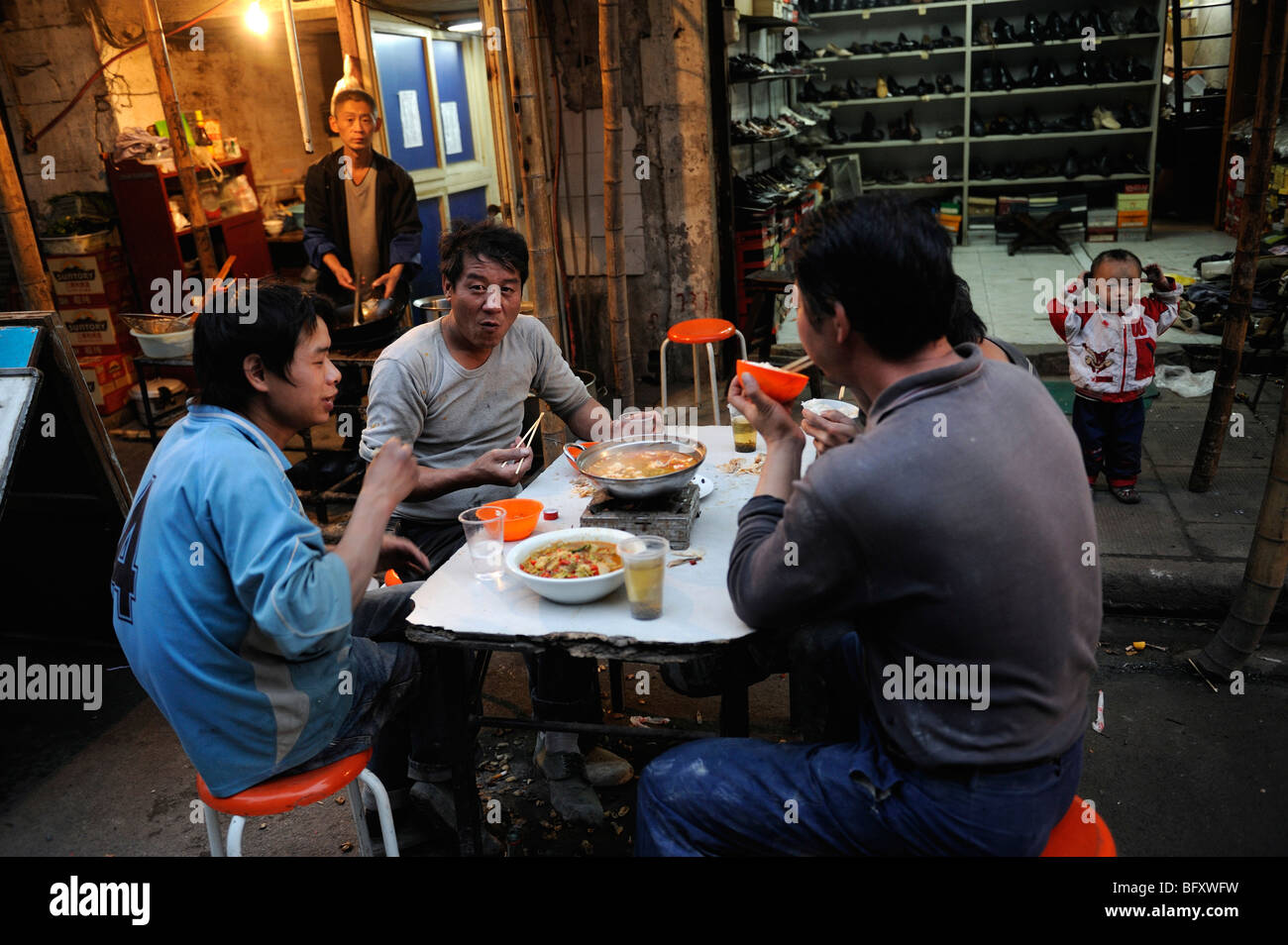 Chinese migrant workers dining together in a small restaurant in ...