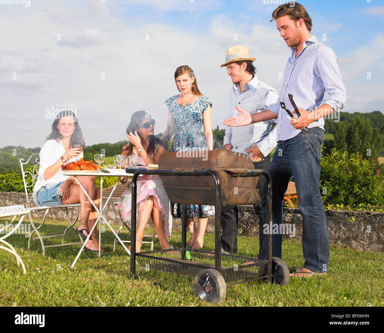 young people having barbecue Stock Photo - Alamy