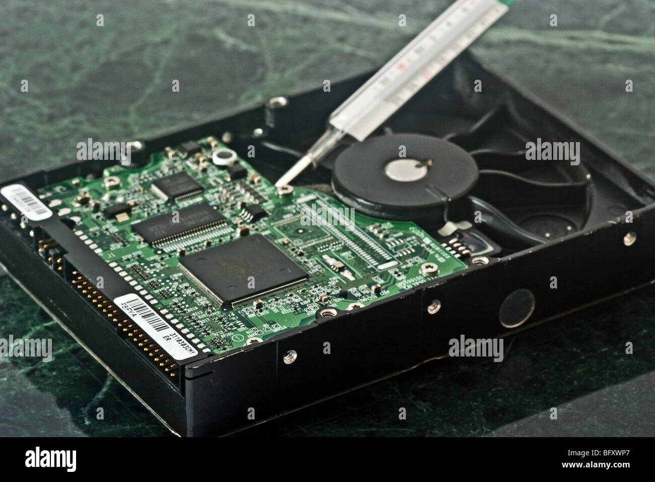 Thermometer sticking in an old IDE hard drive Stock Photo - Alamy