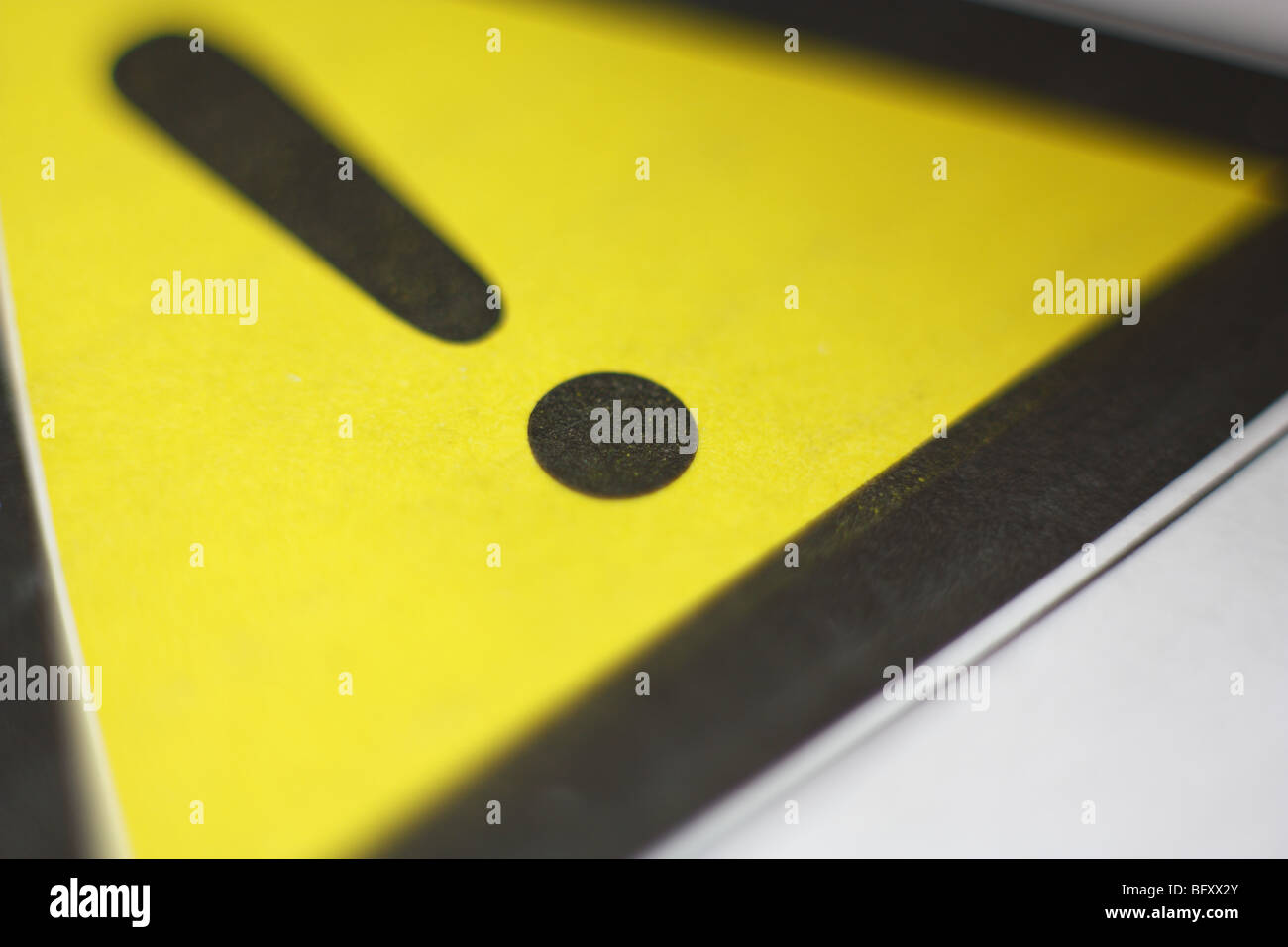 A yellow and black warning sign Stock Photo - Alamy